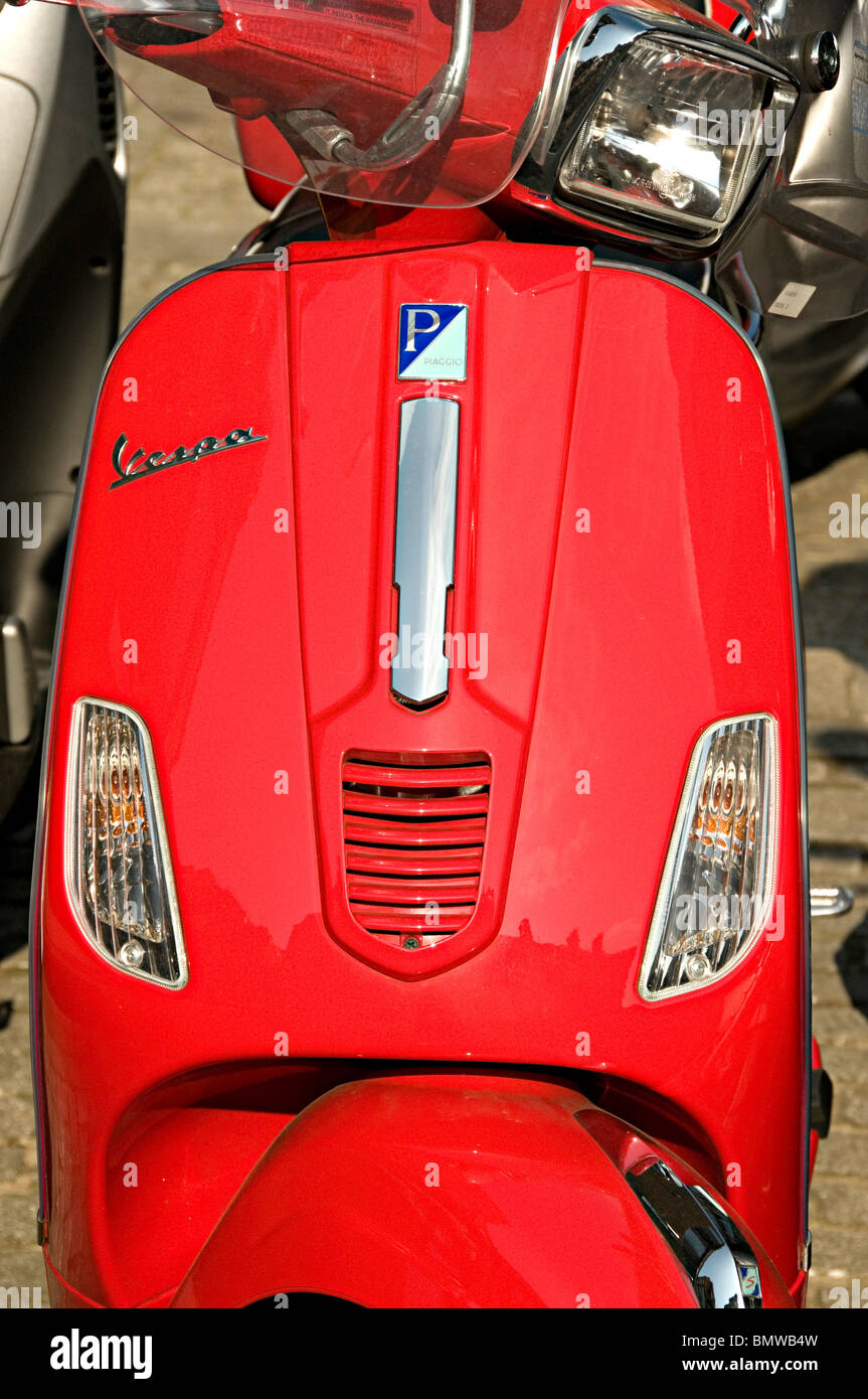 a Bright red scooter moped parked in london Stock Photo - Alamy