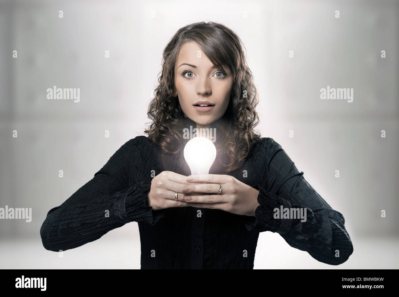 Young girl holding a light bulb Stock Photo - Alamy