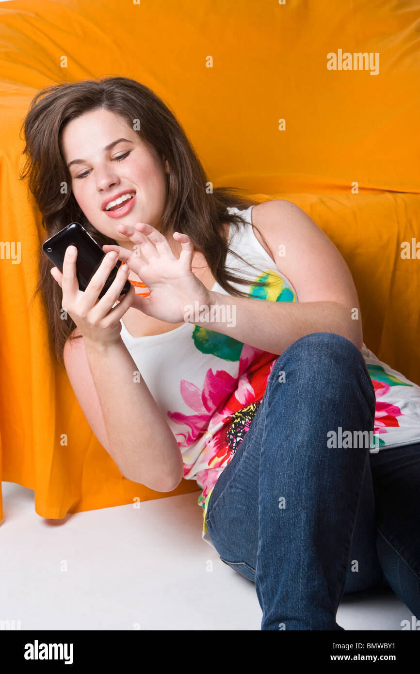 Woman laying on the floor with mobile phone camera hi-res stock ...