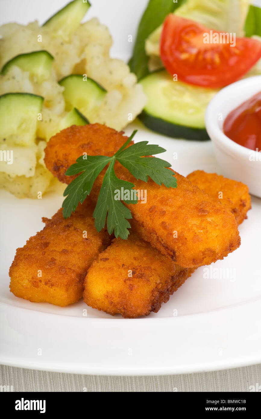 three fish fingers and potatoe salad Stock Photo - Alamy