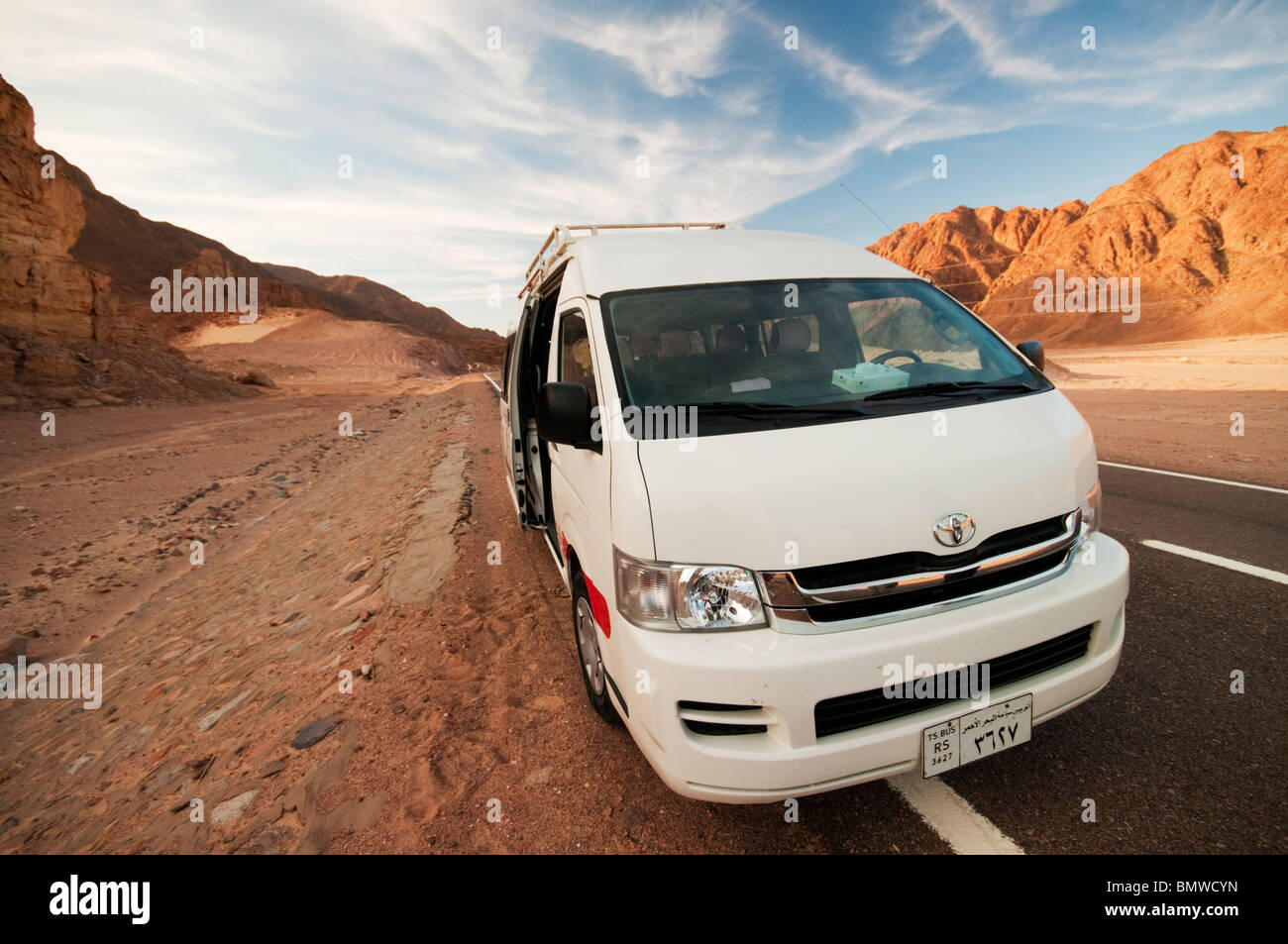An Egyptian tourist vehicle parked at the side of a desert road ...