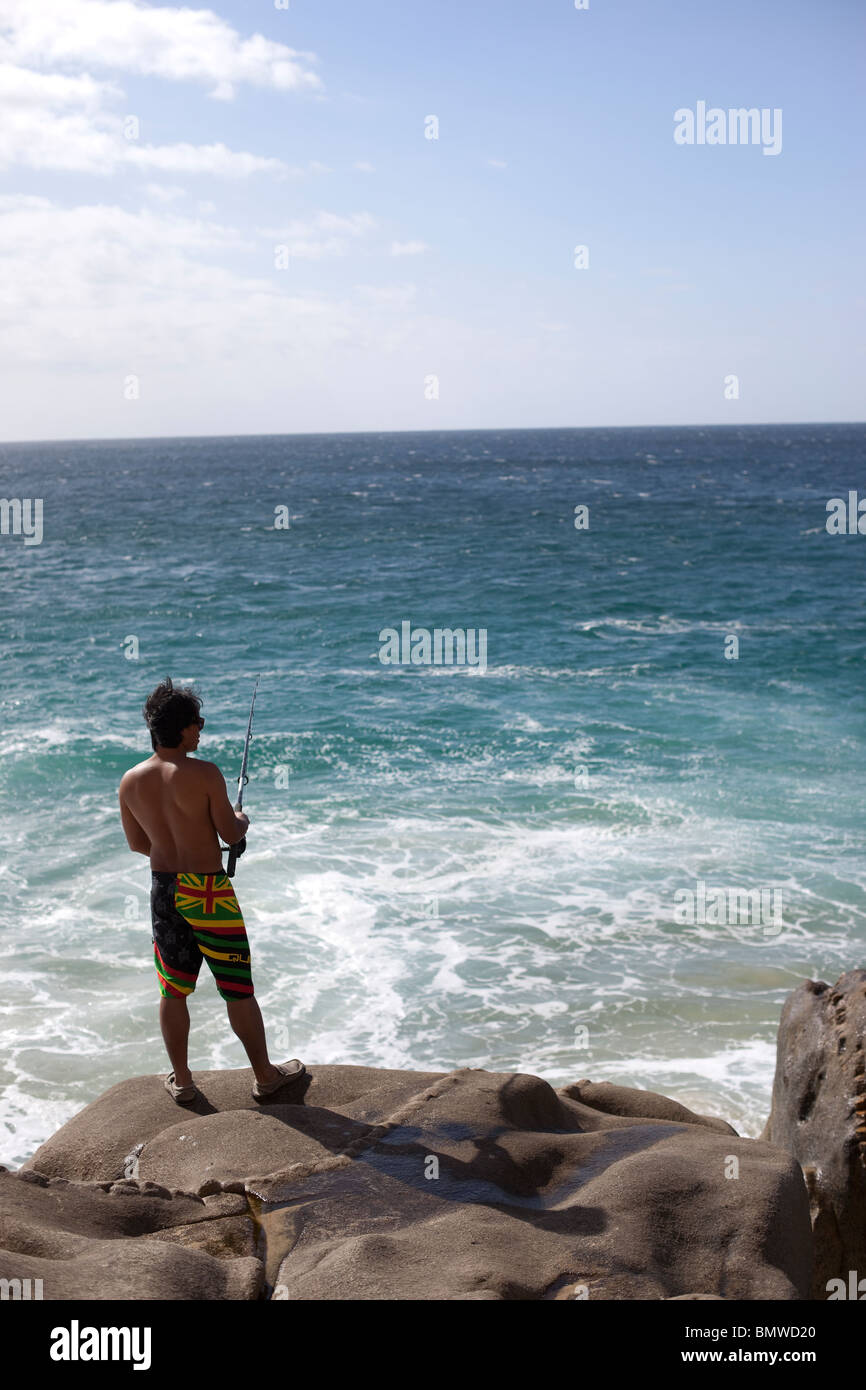 man fishing off the rocks in mexico Stock Photo - Alamy