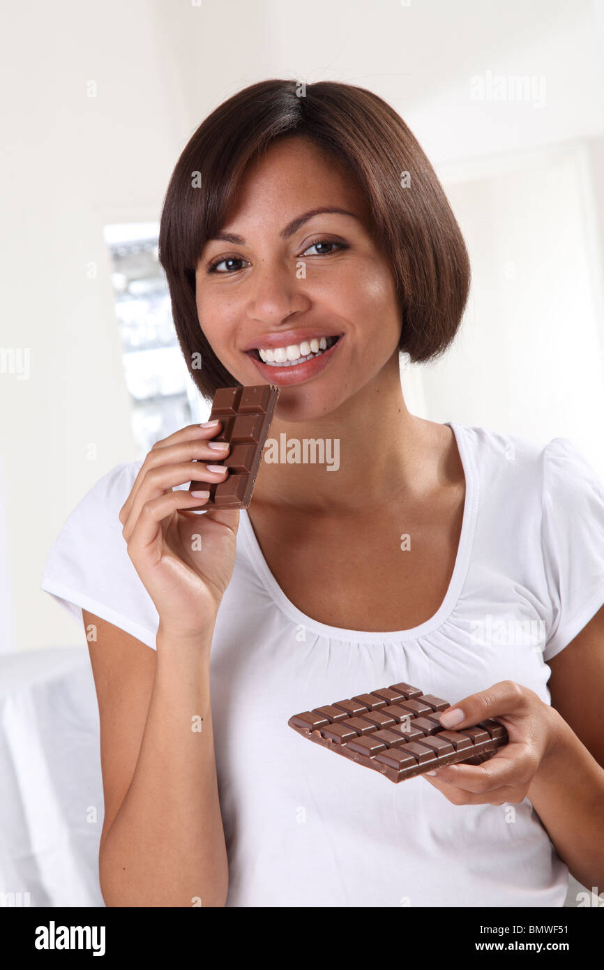 WOMAN EATING CHOCOLATE Stock Photo - Alamy