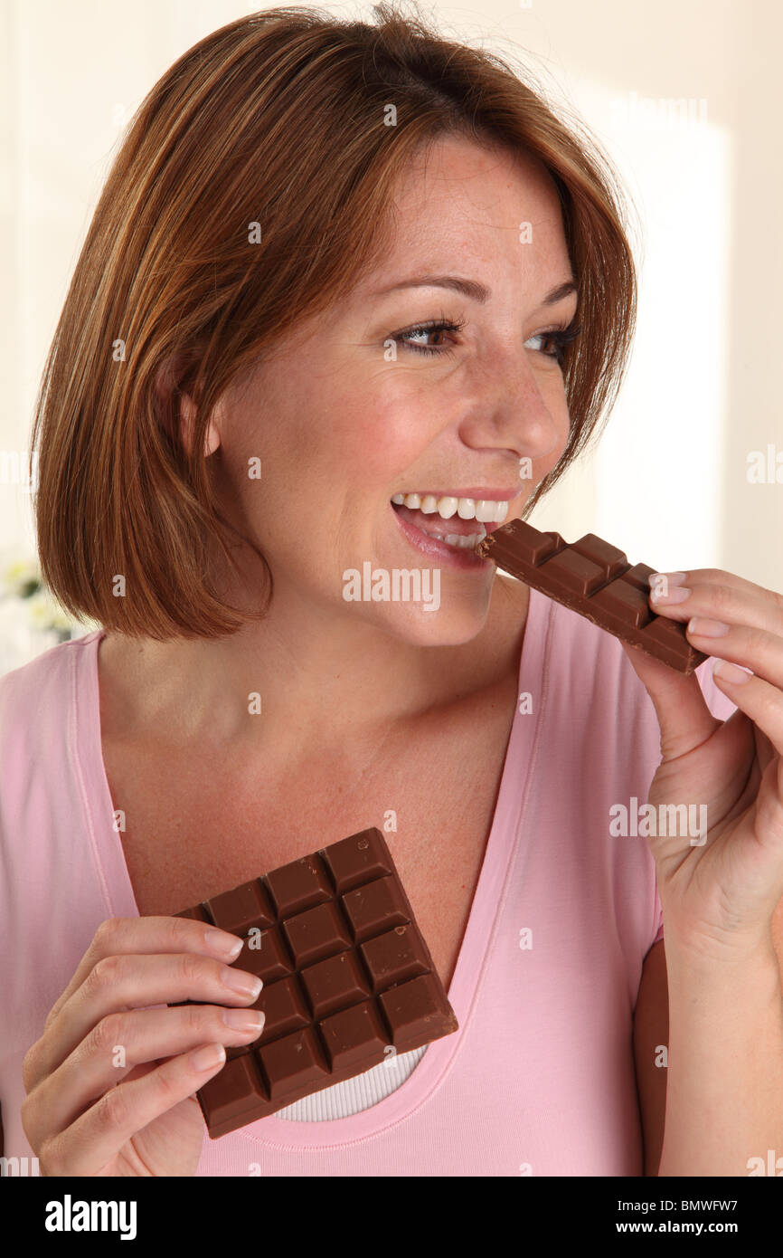 WOMAN EATING CHOCOLATE Stock Photo - Alamy