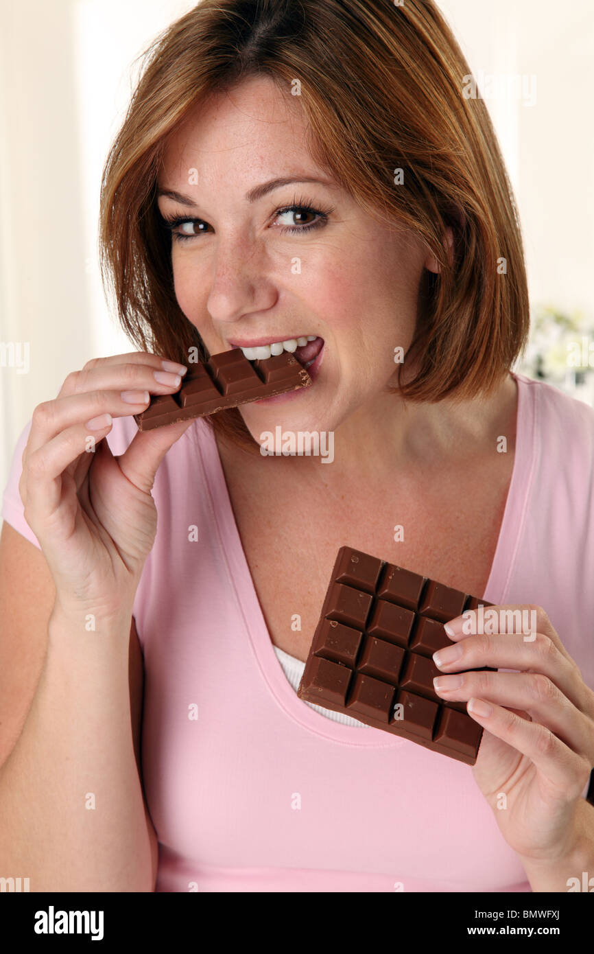 WOMAN EATING CHOCOLATE Stock Photo - Alamy