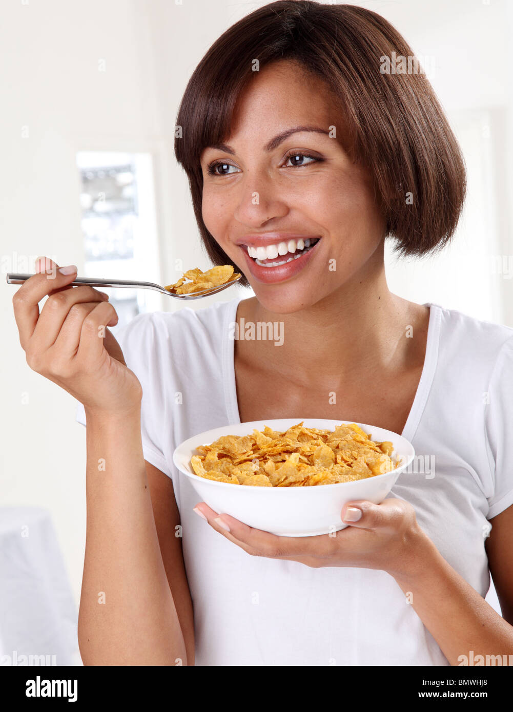 WOMAN EATING CORNFLAKES Stock Photo - Alamy