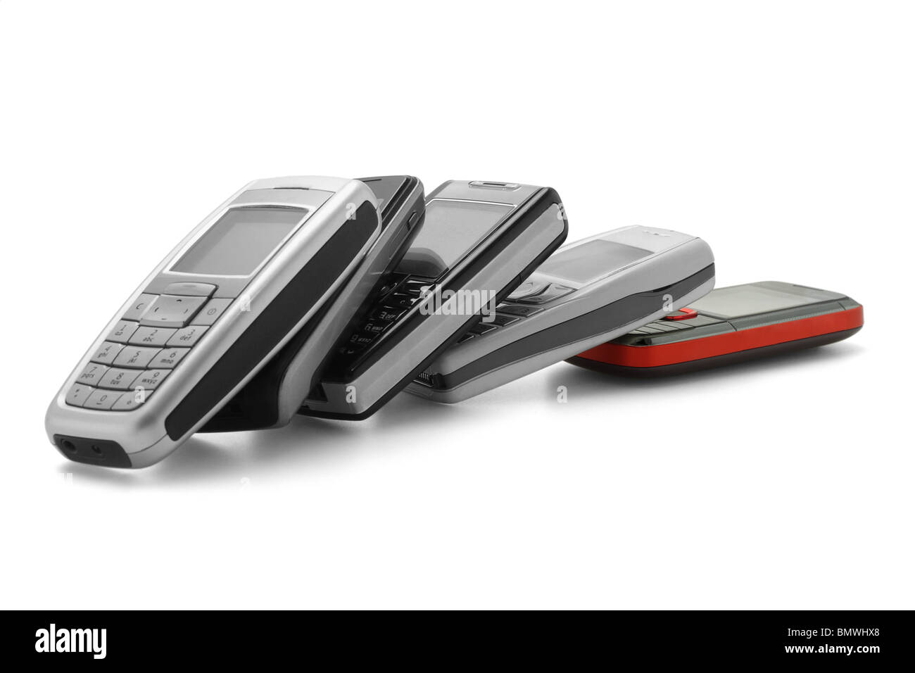 Row of assorted cellphones arranged on white background Stock Photo - Alamy