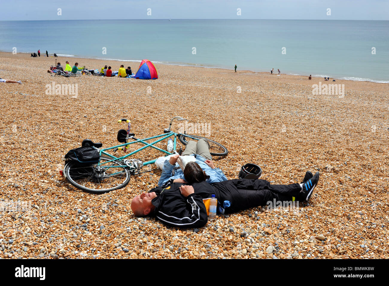 Participants relax on the beach after taking part in the London to ...