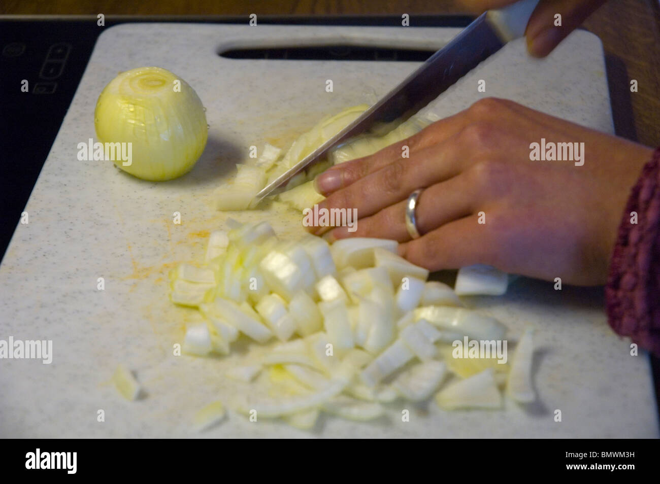 Married woman dicing an onion Stock Photo - Alamy