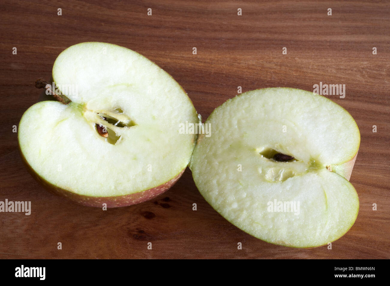 Eating apple cut in half Stock Photo - Alamy
