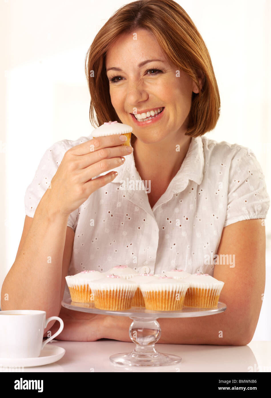 WOMAN EATING A CUPCAKE Stock Photo - Alamy