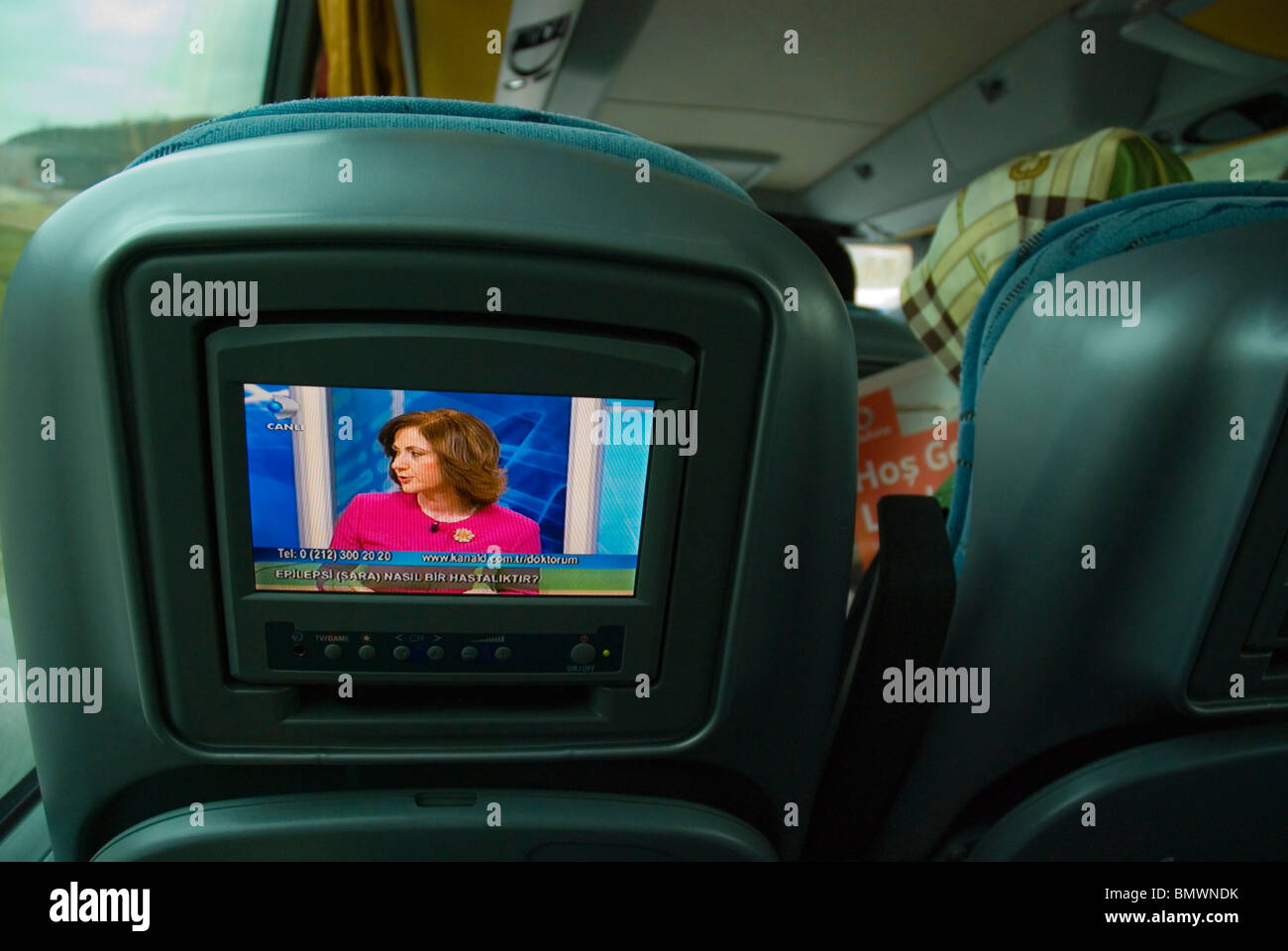 Tv screen attached to bench on bus in Turkey Stock Photo - Alamy