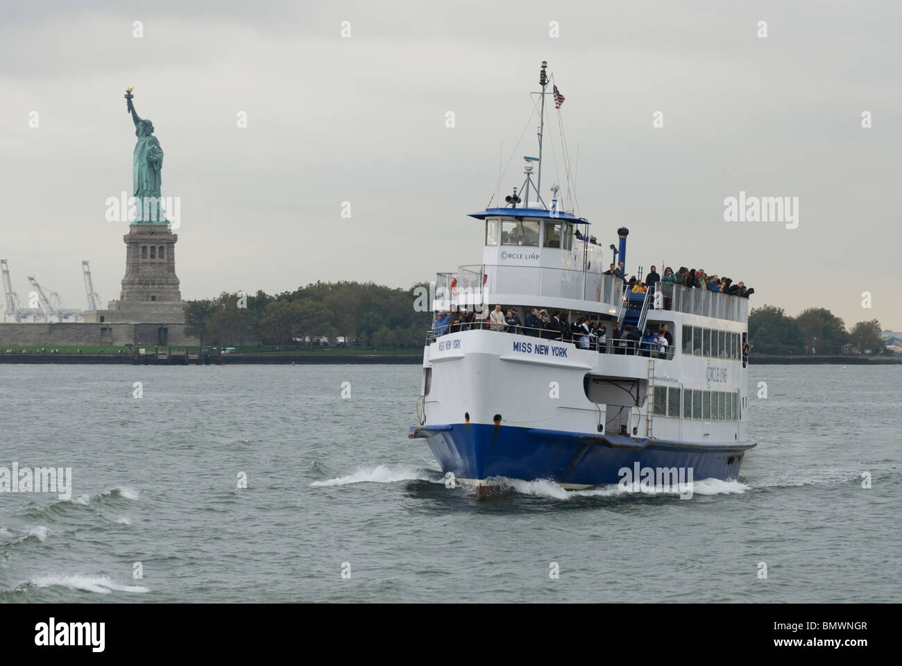 A sightseeing boat on a trip around the Statue of Liberty on New York's ...