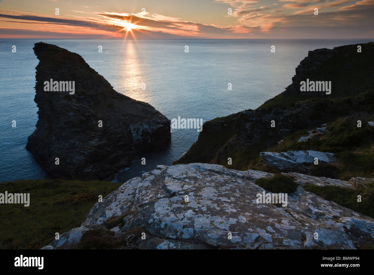 Sun setting behind Long Island near Trevalga on the North Cornish coast ...