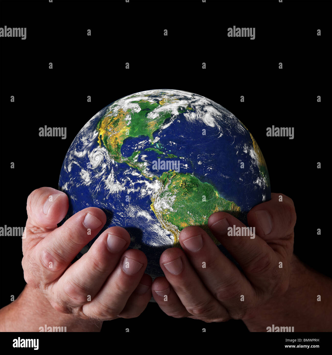 Hands holding world on isolated black background Stock Photo - Alamy