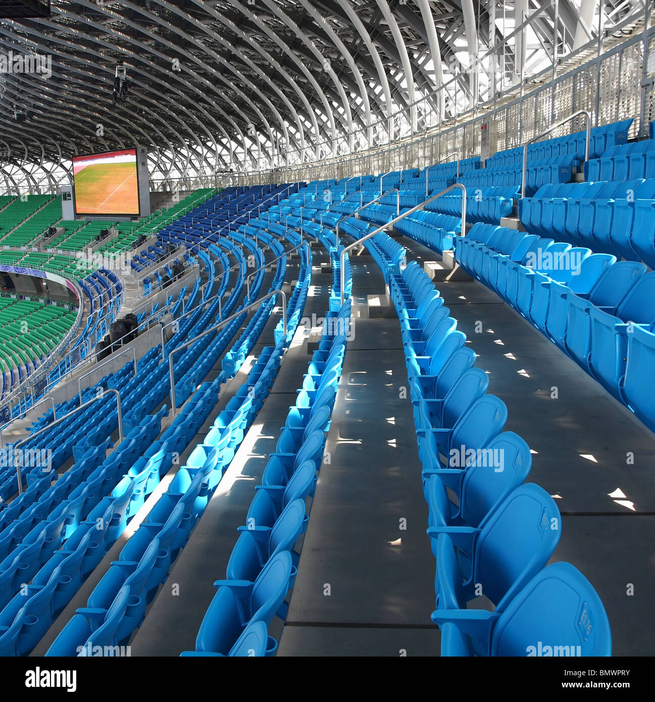 A large stadium with rows of blue folding plastic chairs Stock Photo ...
