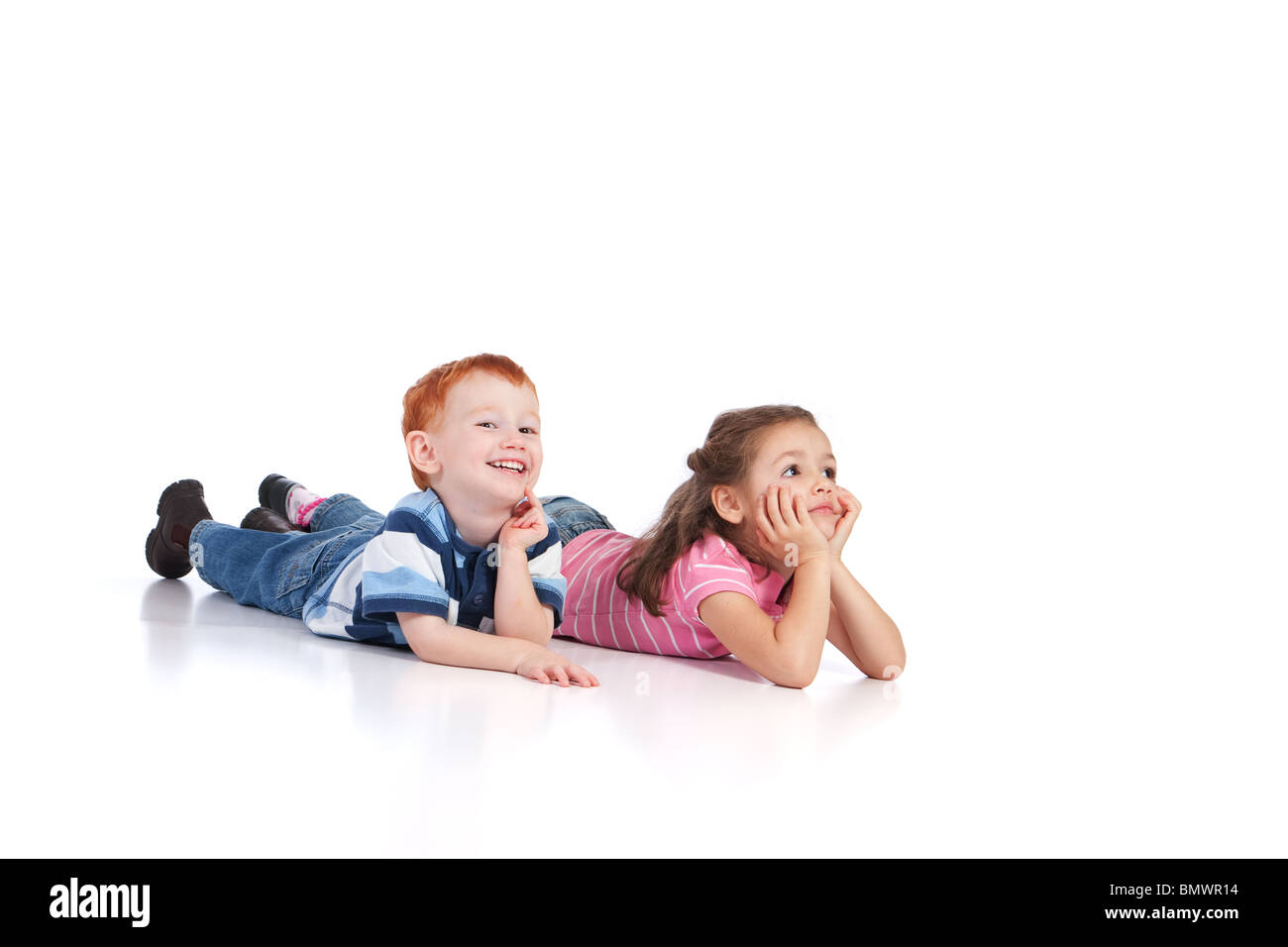 Two kids lying on floor. Isolated background, reflection foreground ...