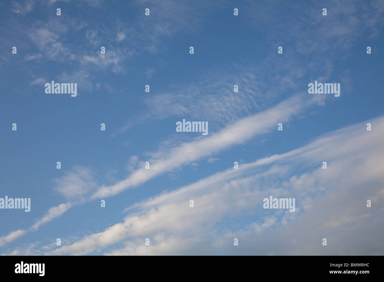 Wispy white clouds make patterns against a blue sky in a late summer ...
