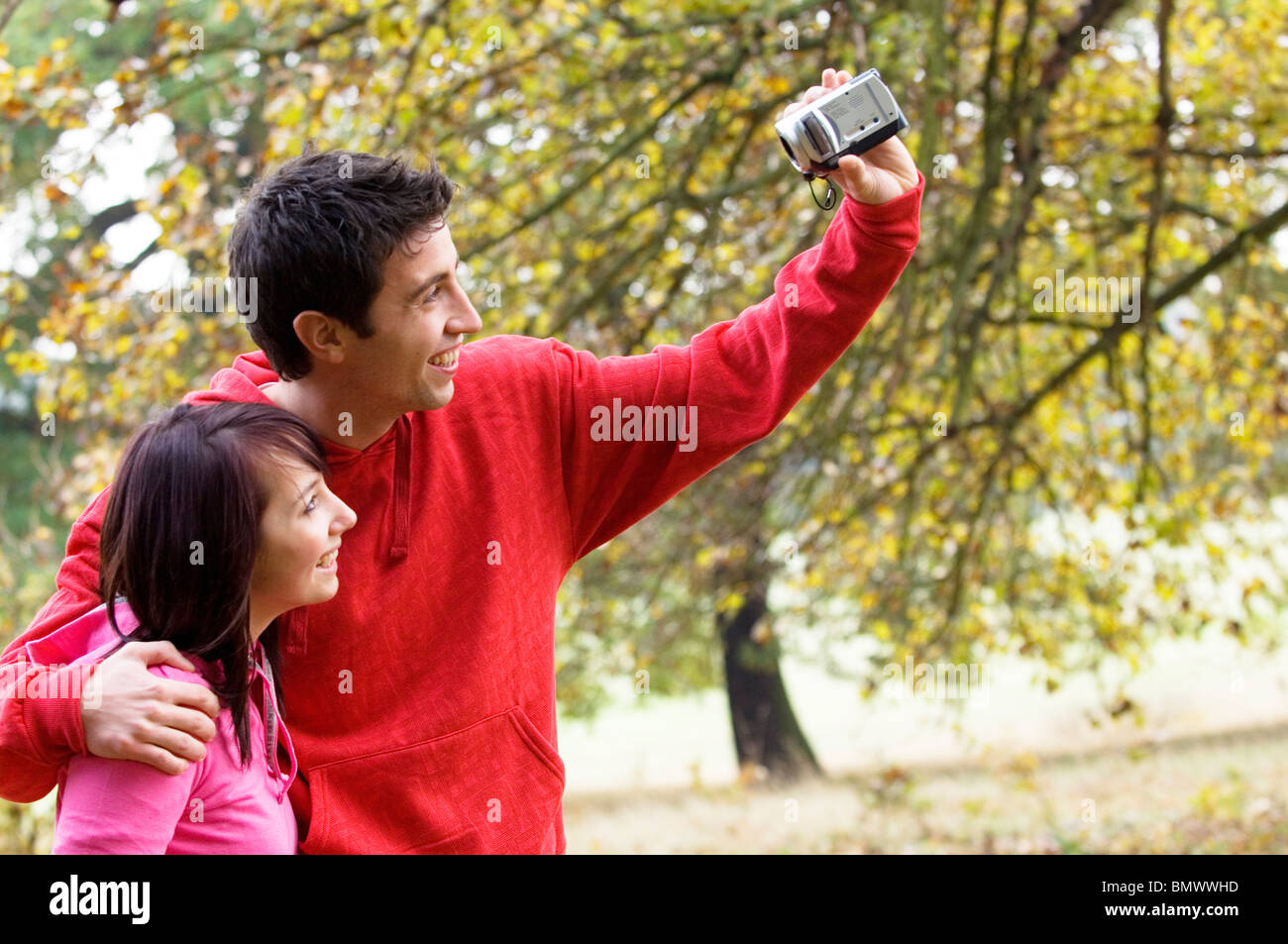 Couple using camcorder Stock Photo - Alamy