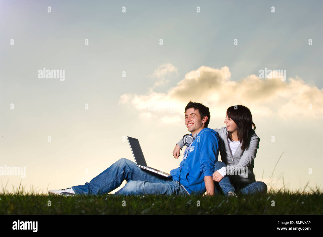 young couple using laptop outdoors Stock Photo - Alamy
