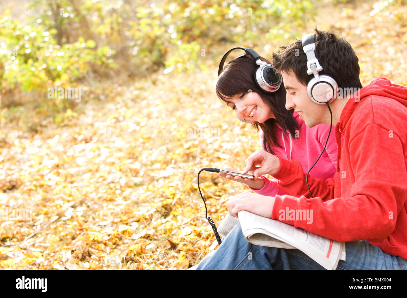 Teenagers listening mp3 park hi-res stock photography and images - Alamy