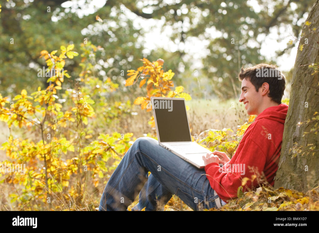 youth using laptop outdoors Stock Photo - Alamy