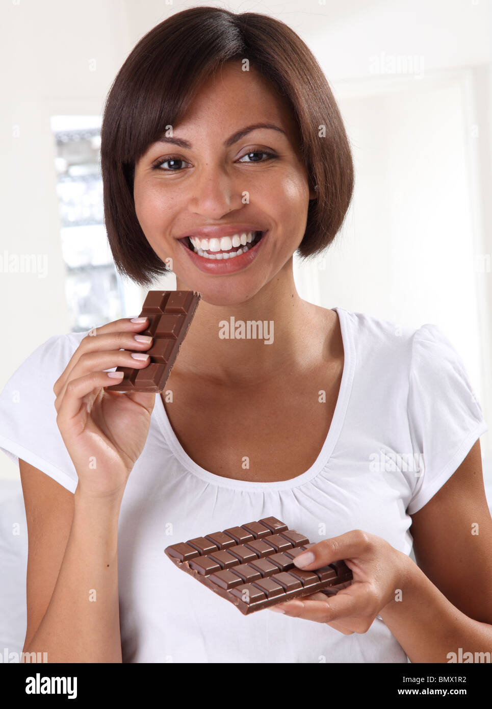 WOMAN EATING CHOCOLATE Stock Photo - Alamy