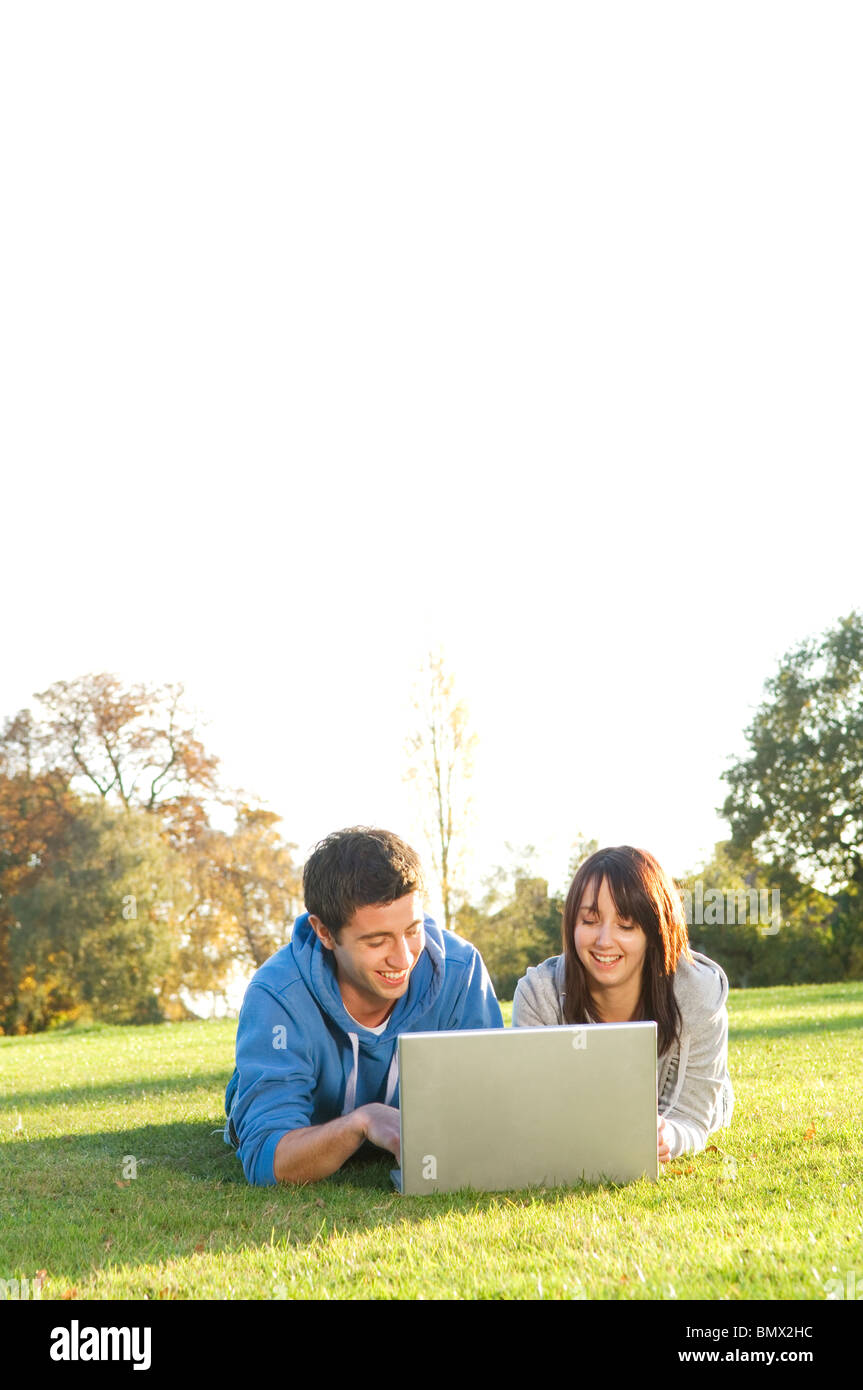 young couple using laptop outdoors Stock Photo - Alamy