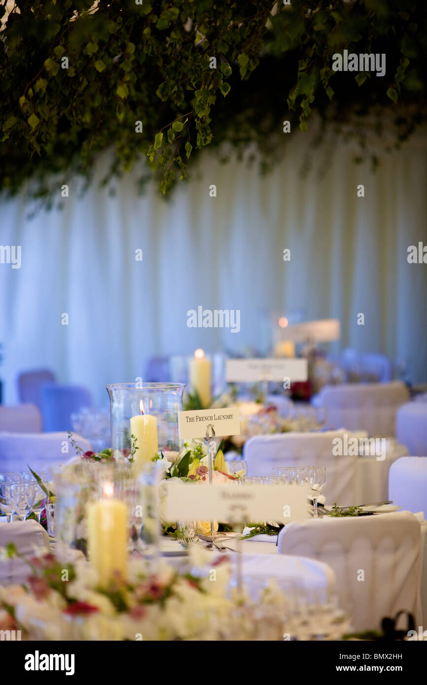 Wedding reception tables laid out in preparation for arrival of guests ...