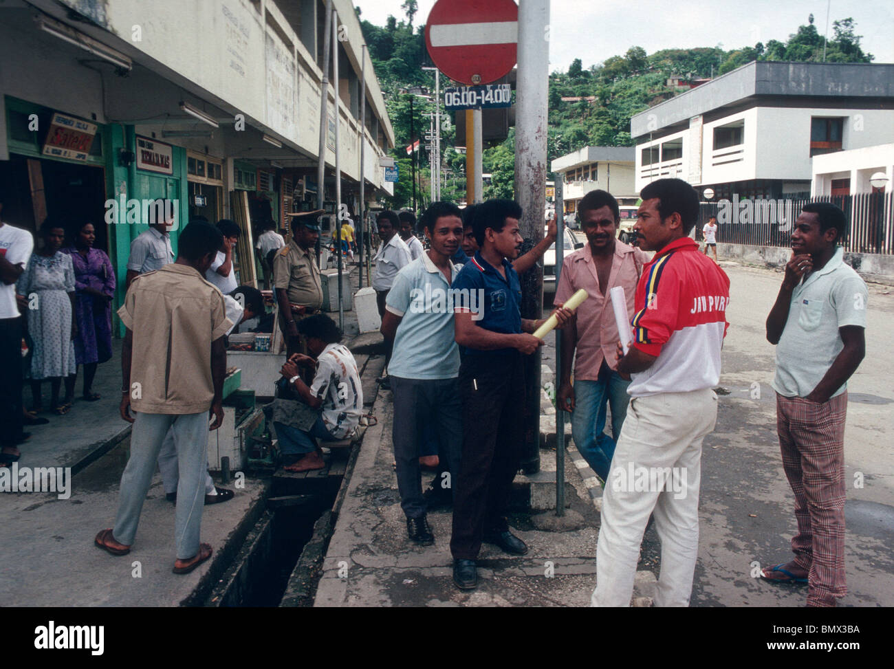 Papuans and Indonesians on a pavement in Jayapura, the capital of West ...