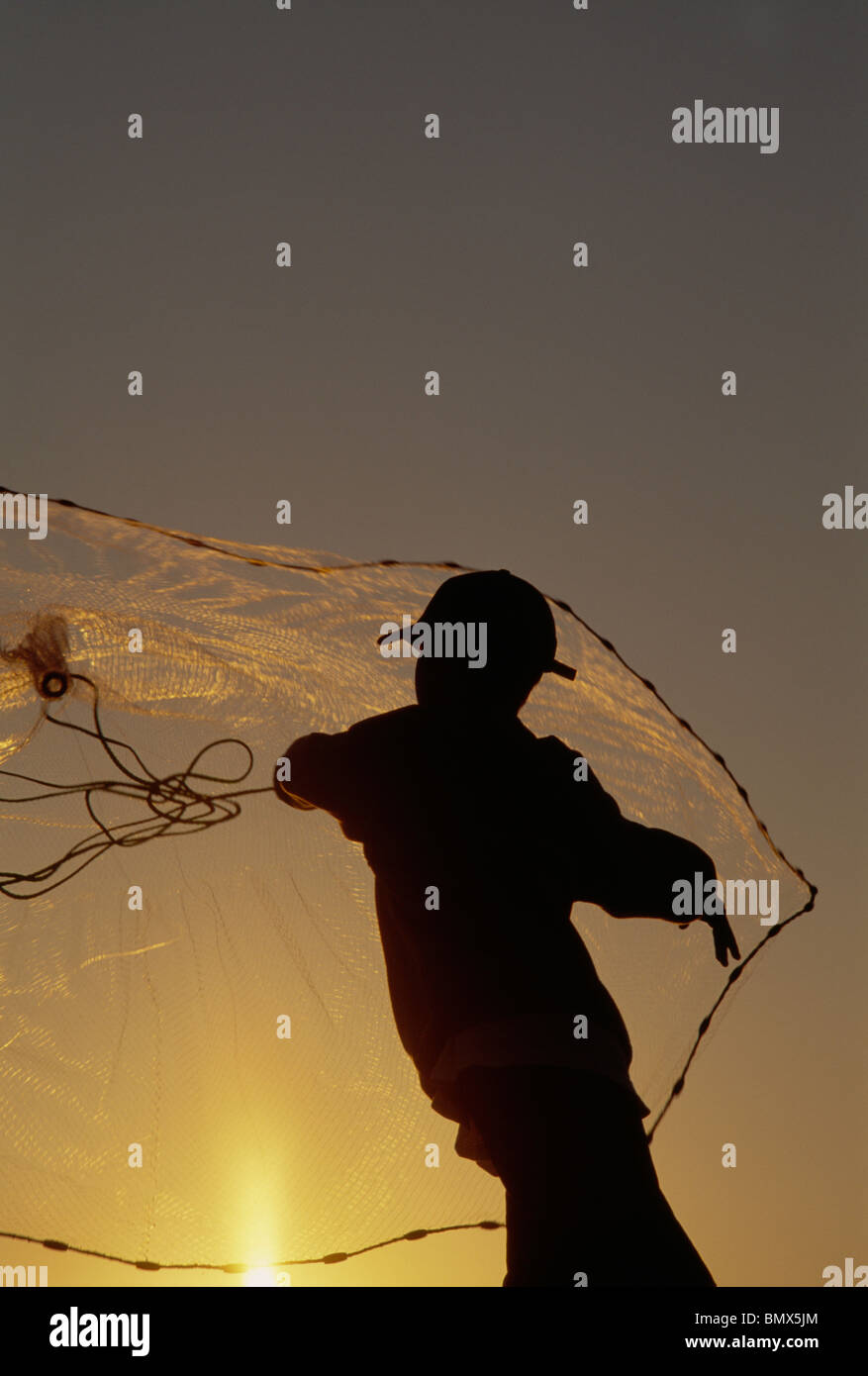 Boy Throwing Cast Net Stock Photo - Alamy
