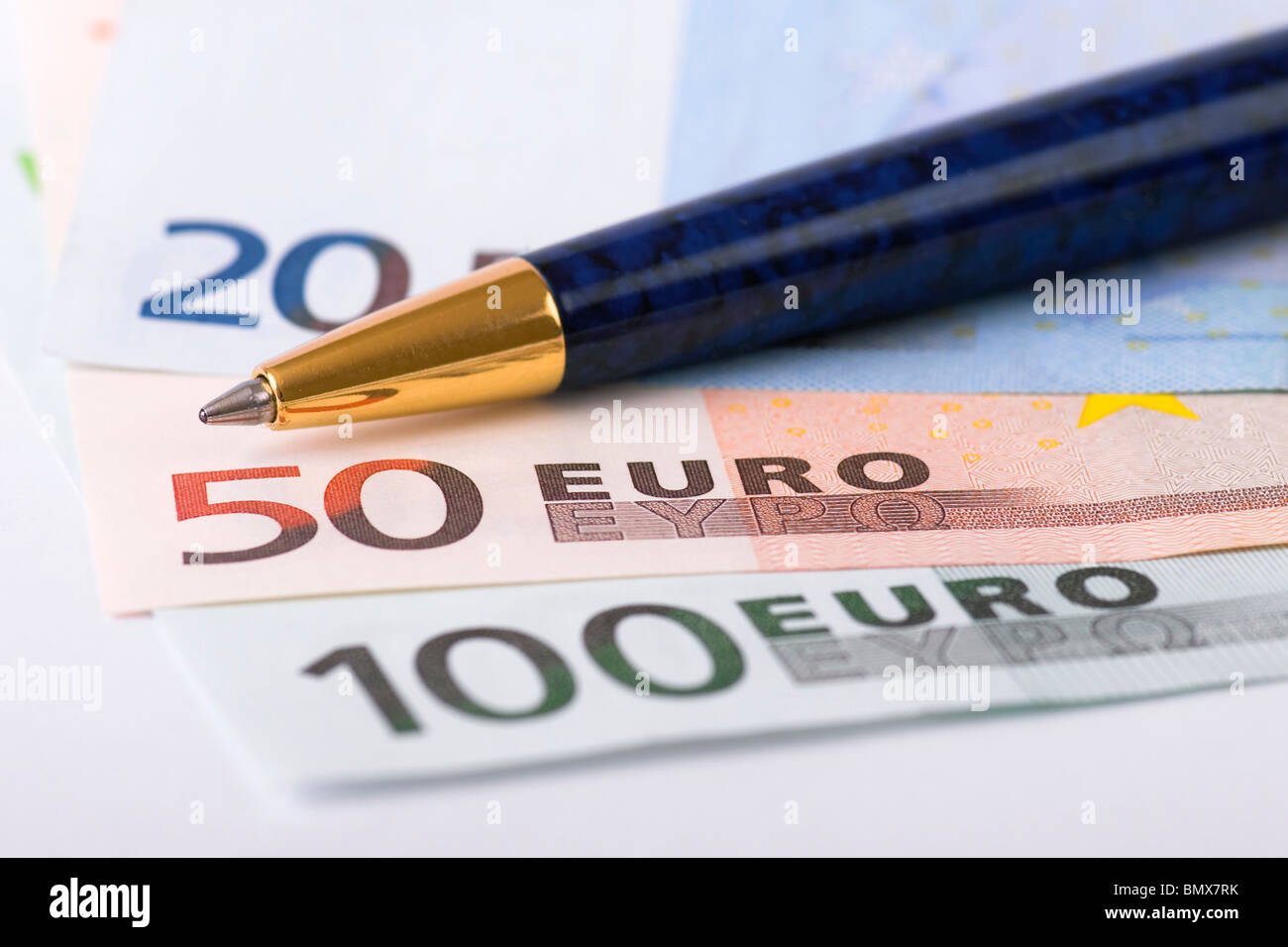 Various euro banknotes with a pen Stock Photo - Alamy