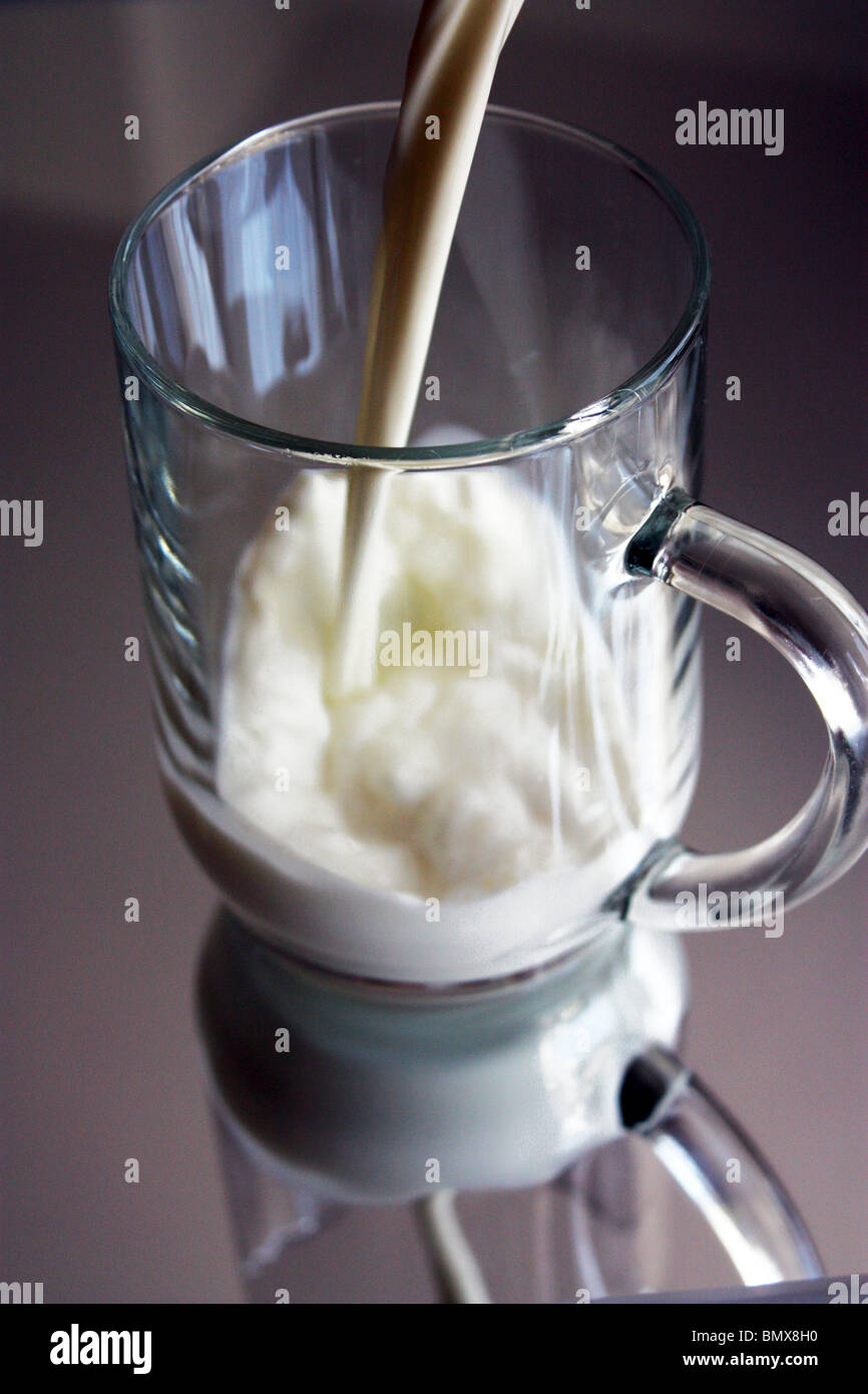 Fresh milk being poured into a glass ready to drink Stock Photo - Alamy