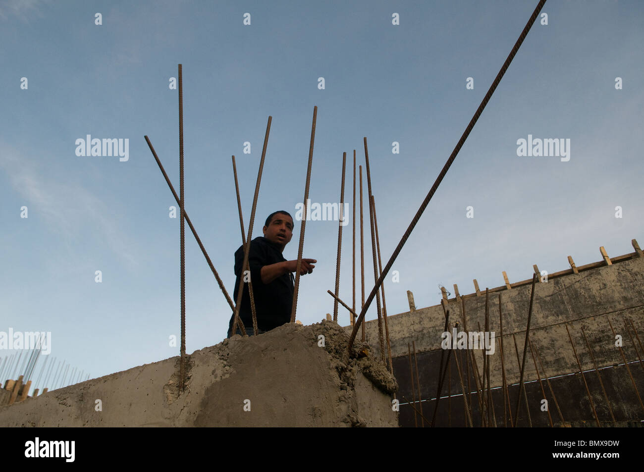 Palestinian construction worker at the site of a new structure in Maale ...