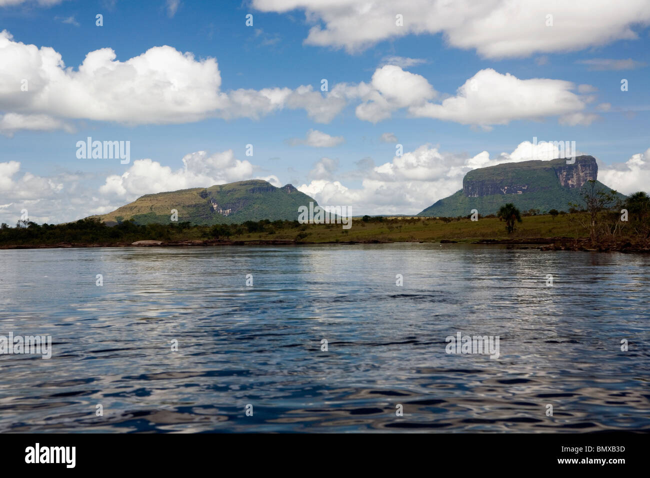 River at the foreground, Savanna and Tepui mountains and white clouds ...