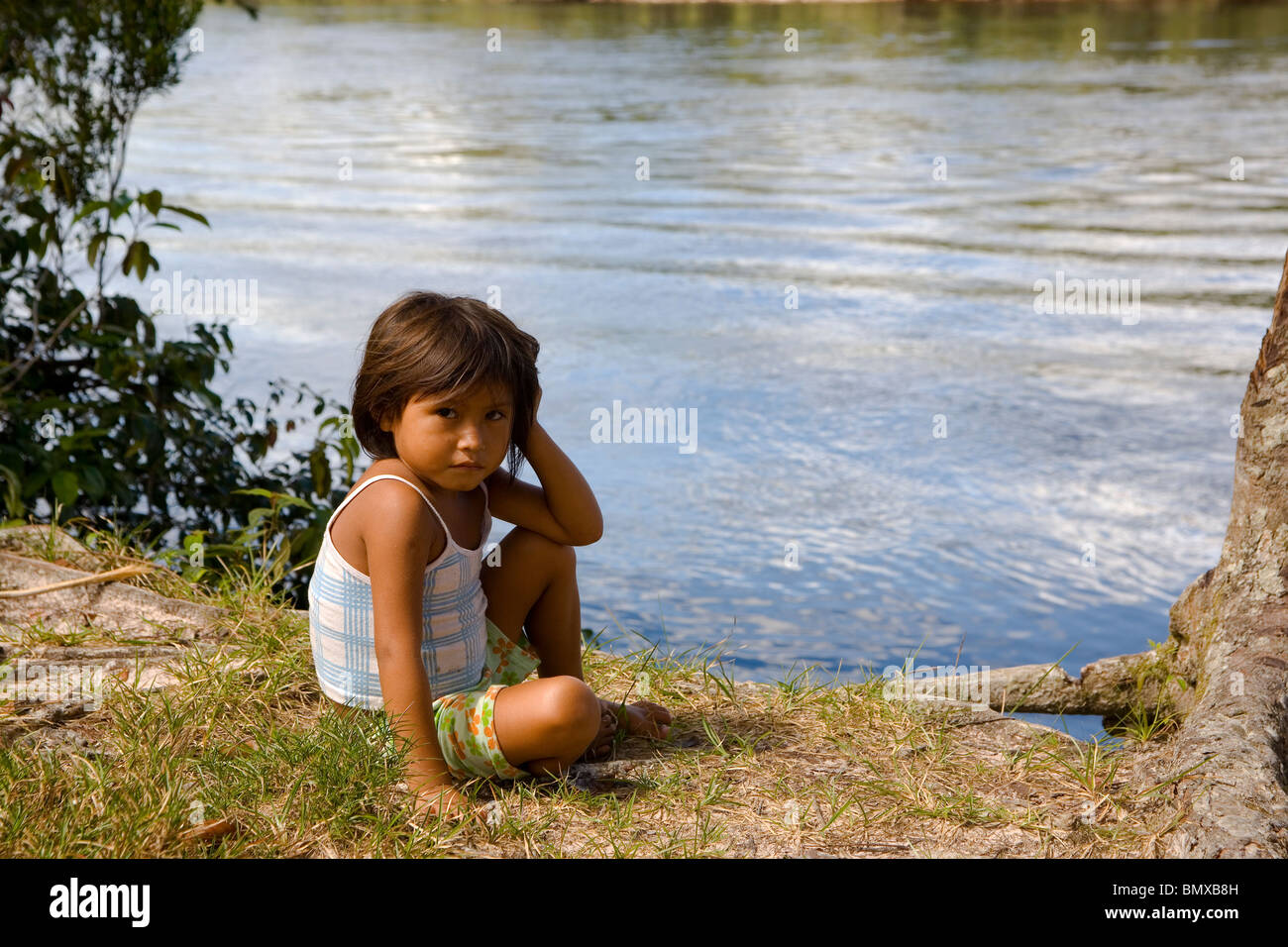 A Pemon Tribe Indigenous Child Sitting Down At The Bank Of One Of ...