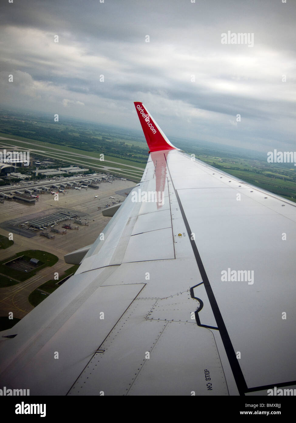Aeroplane / Airplane wing during take-off / flight. Red tip to wing ...