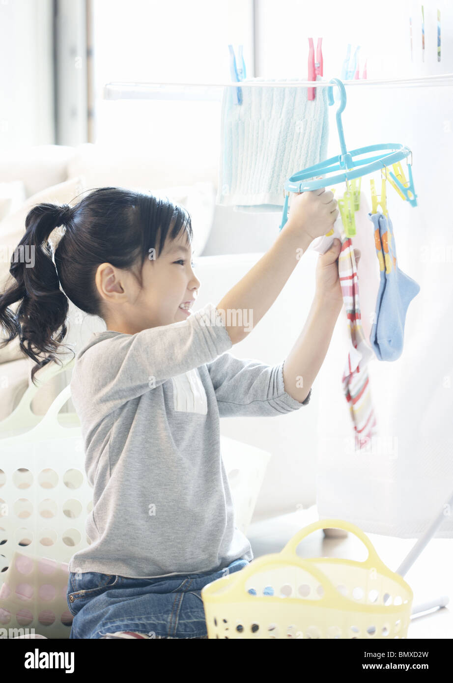 Girl hanging out the laundry Stock Photo - Alamy