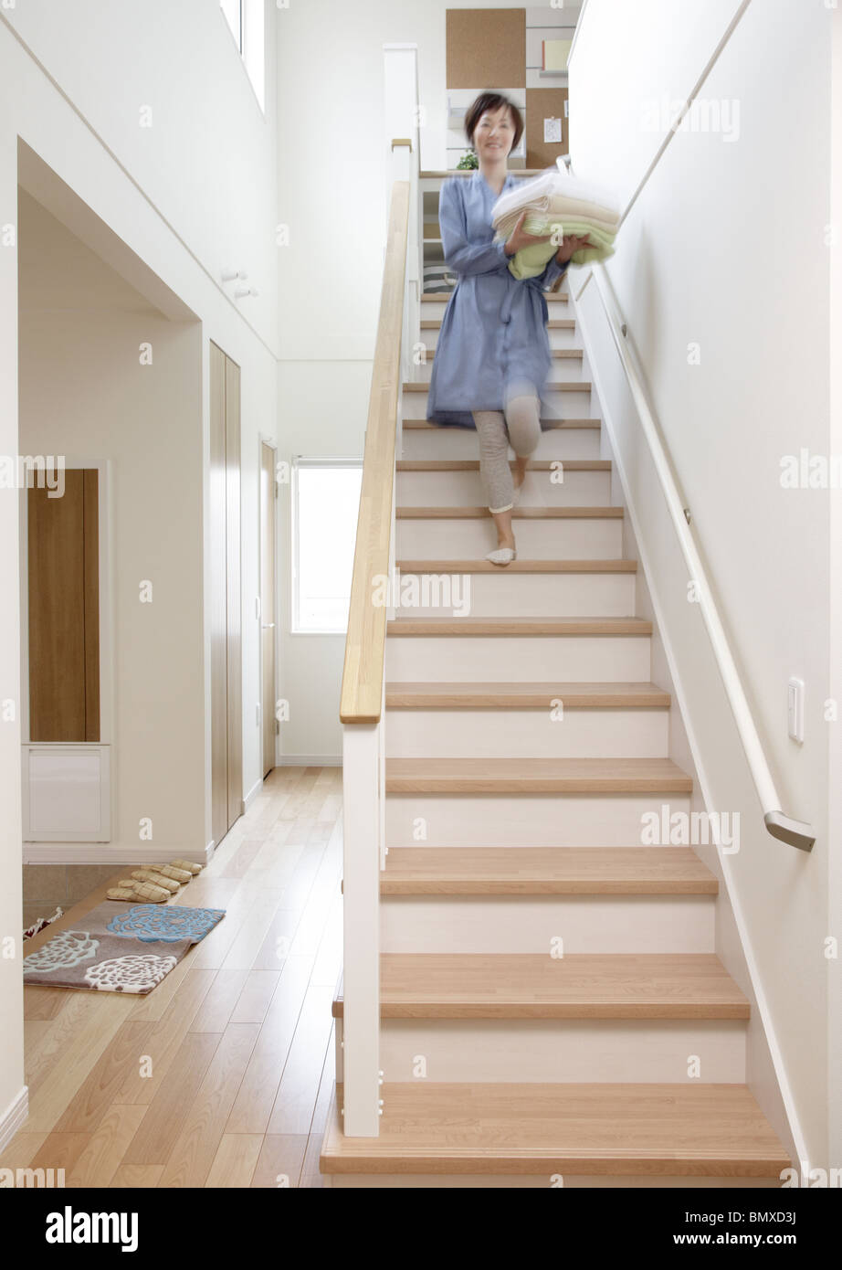 Woman downing stairs Stock Photo - Alamy