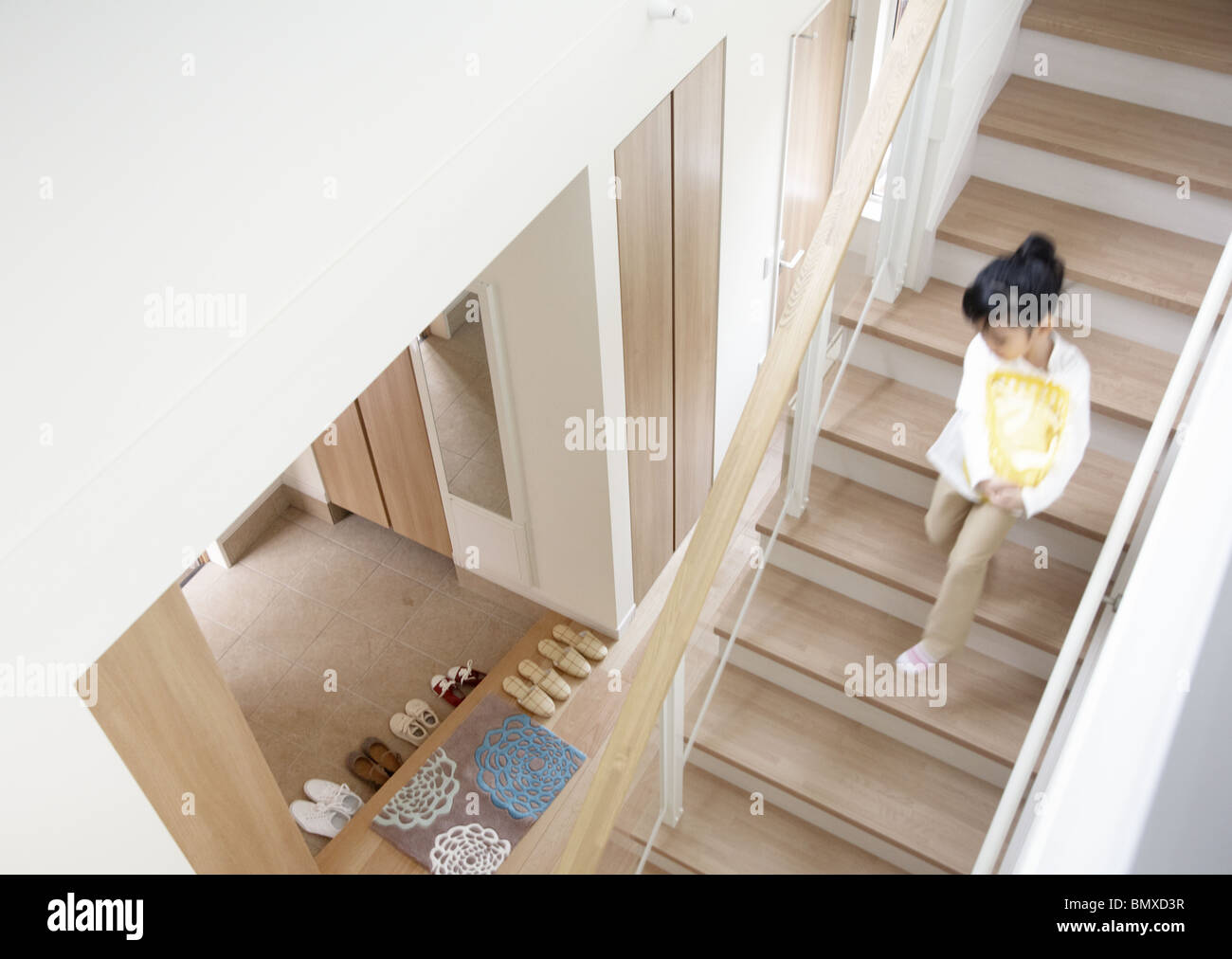 Girl downing stairs Stock Photo - Alamy