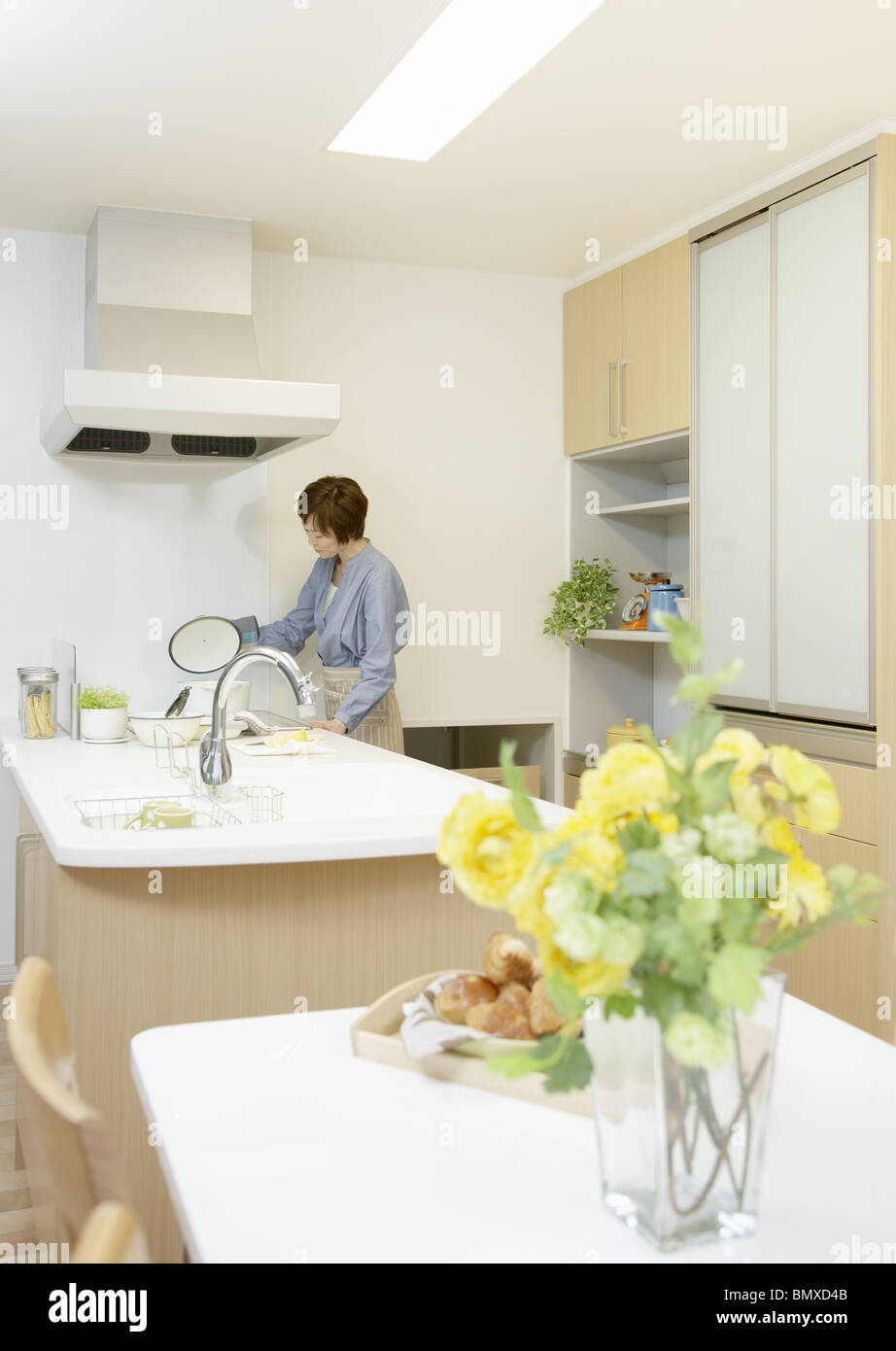 Woman in kitchen Stock Photo - Alamy