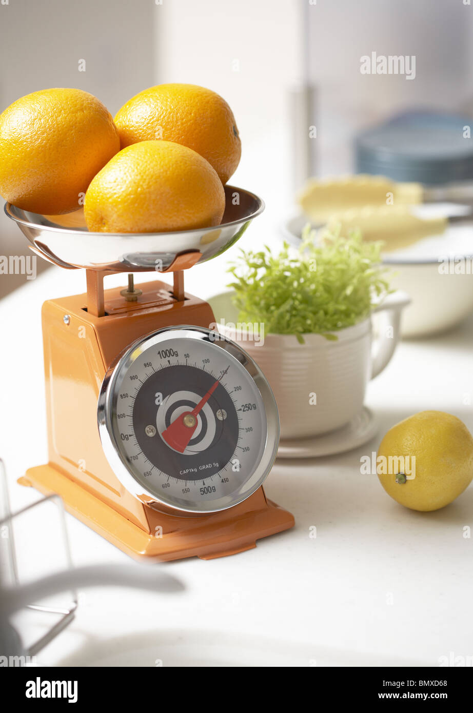 Kitchen scale and Orange Stock Photo - Alamy