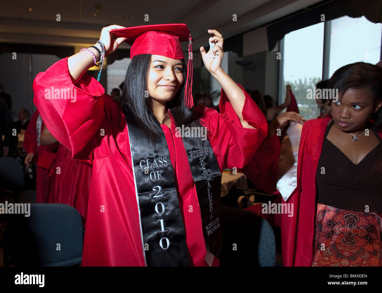 Hispanic female student prepares for her high school graduation ...