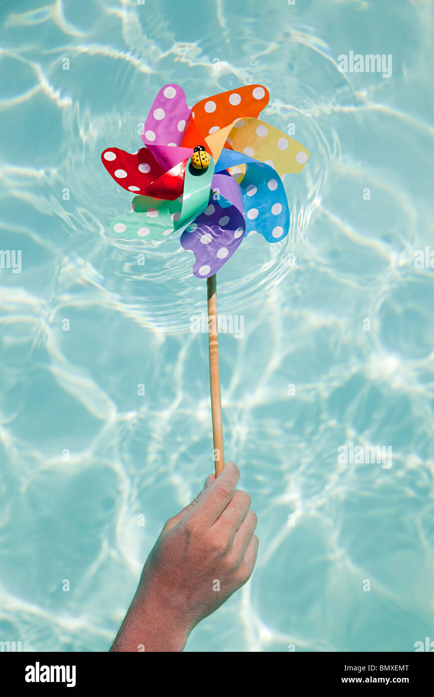 Person holding pinwheel in swimming pool Stock Photo - Alamy