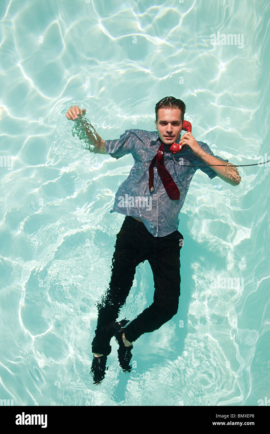 Office worker on telephone in swimming pool Stock Photo - Alamy