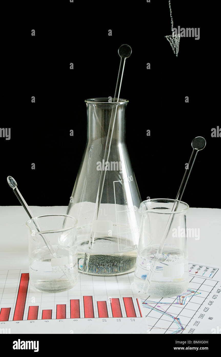 Flask and beakers on graphs Stock Photo - Alamy