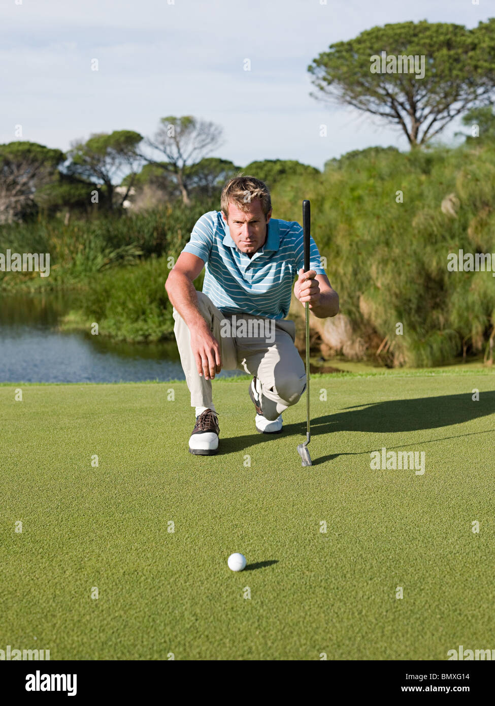 Man crouching playing golf hi-res stock photography and images - Alamy