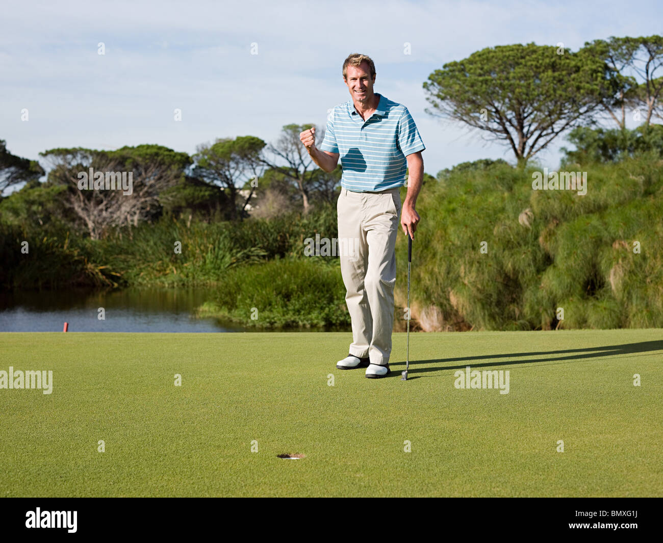 Ecstatic man playing golf Stock Photo - Alamy