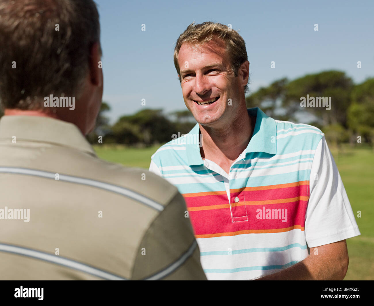 Two mature men playing golf together Stock Photo - Alamy