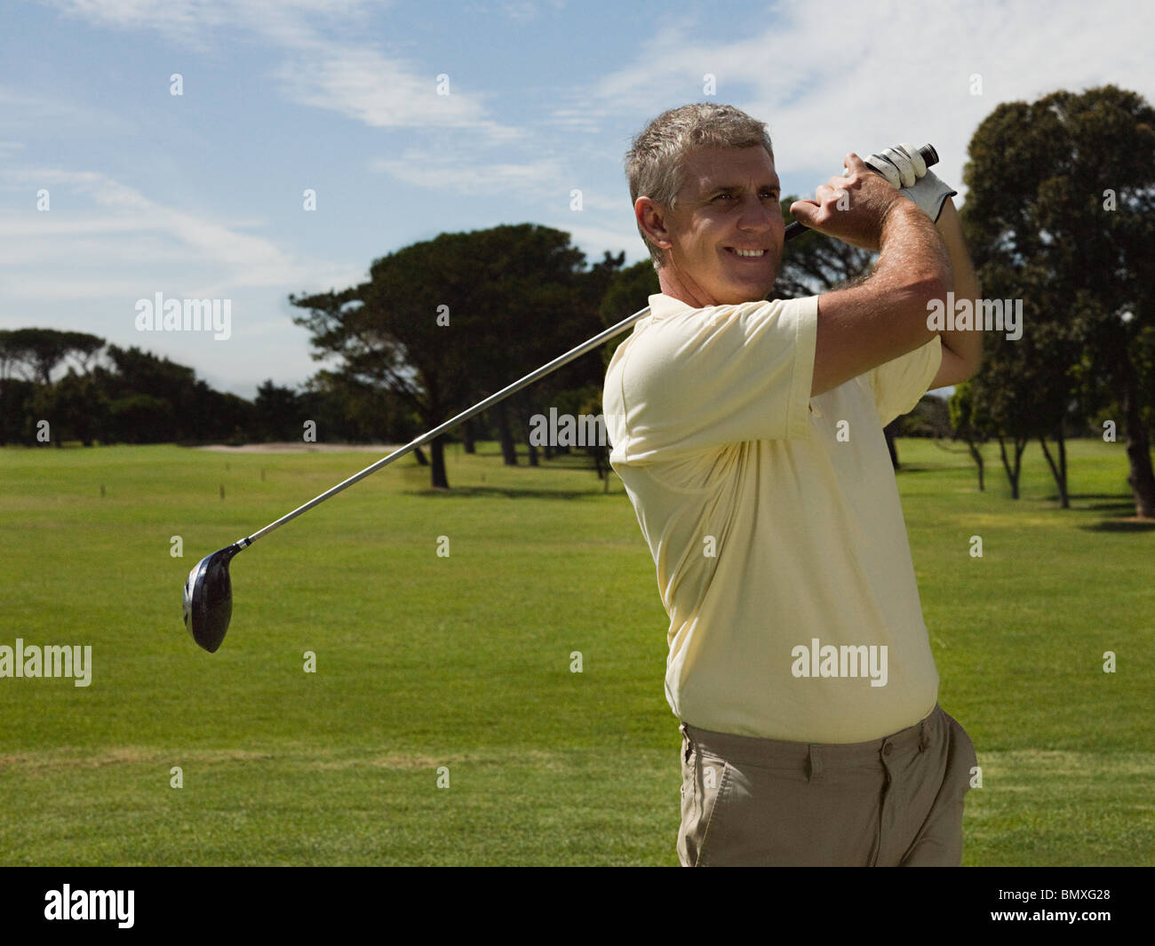 Man playing golf on golf course Stock Photo - Alamy